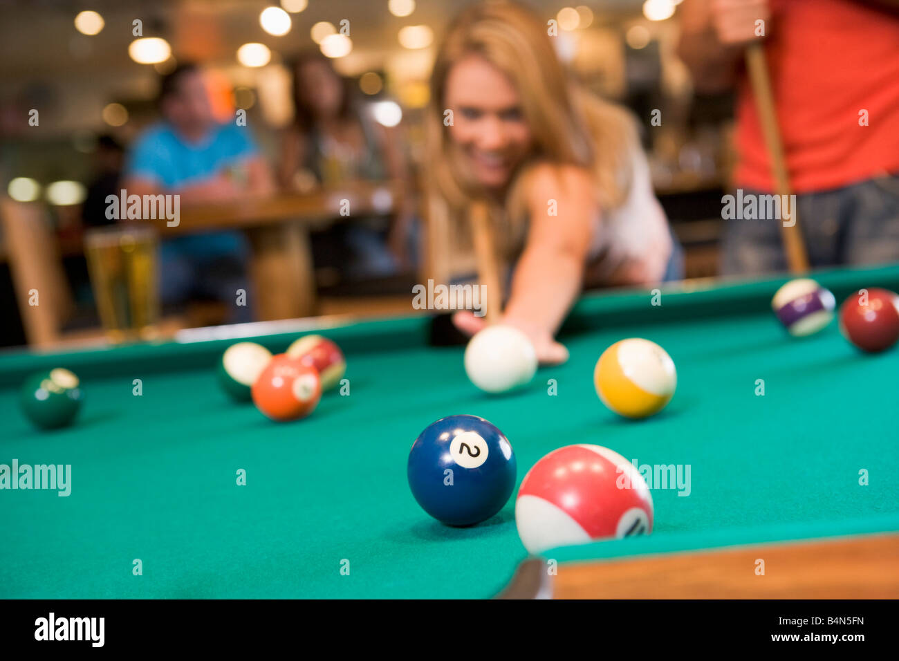Woman playing pool Stock Photo - Alamy