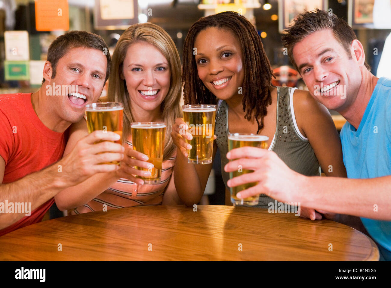 Two couples having beer together Stock Photo - Alamy