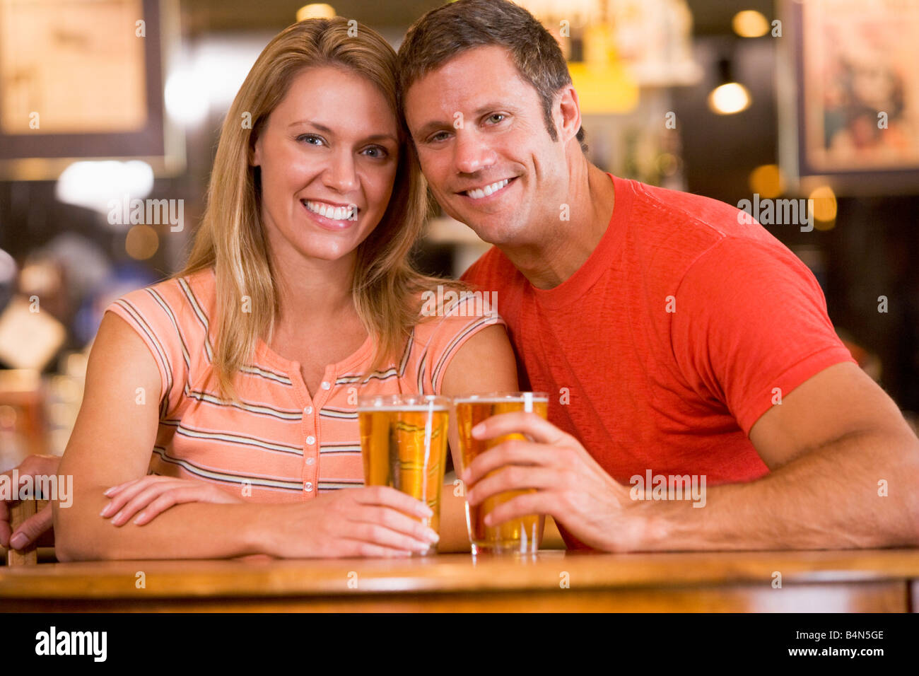 Couple having beer together Stock Photo - Alamy