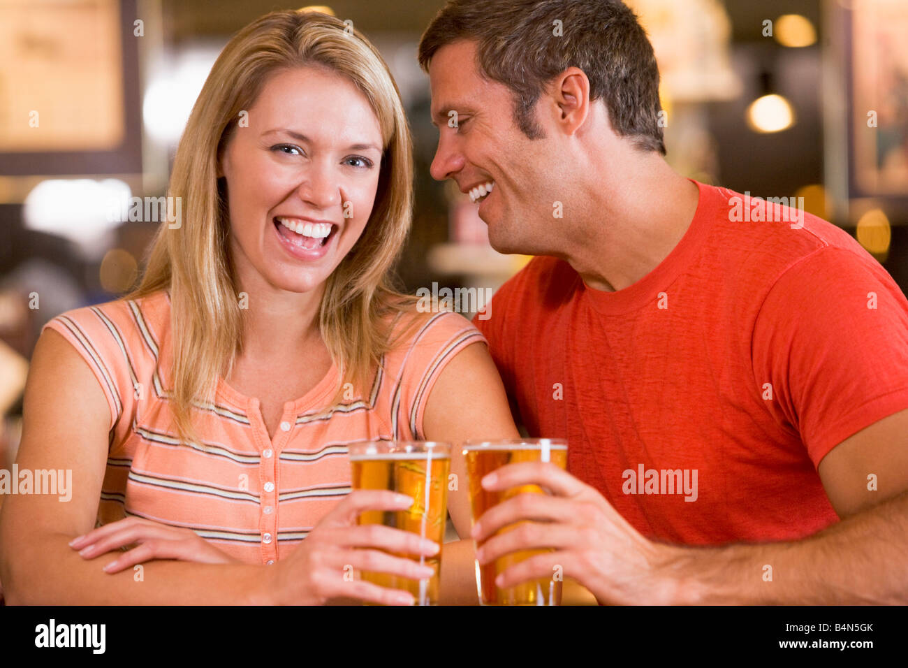 Couple having beer together Stock Photo - Alamy