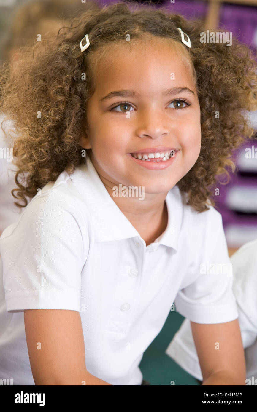 Student in class sitting on floor smiling (selective focus Stock Photo ...