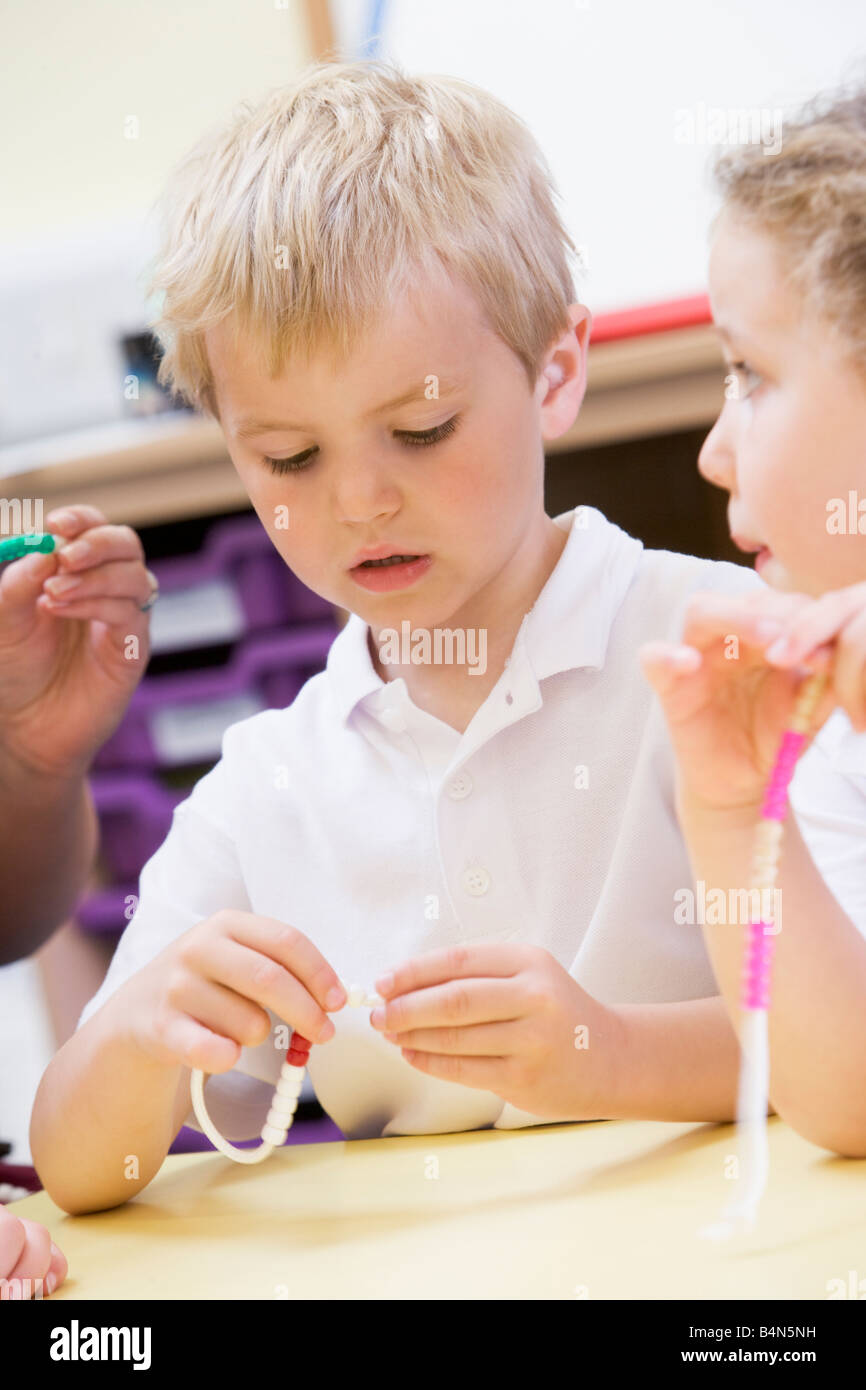Students in math class using counting beads (selective focus Stock ...
