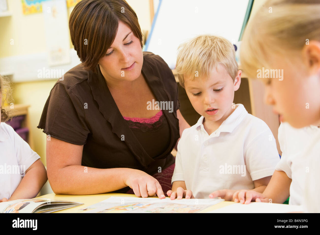 Three year old reading in classroom hi-res stock photography and images ...
