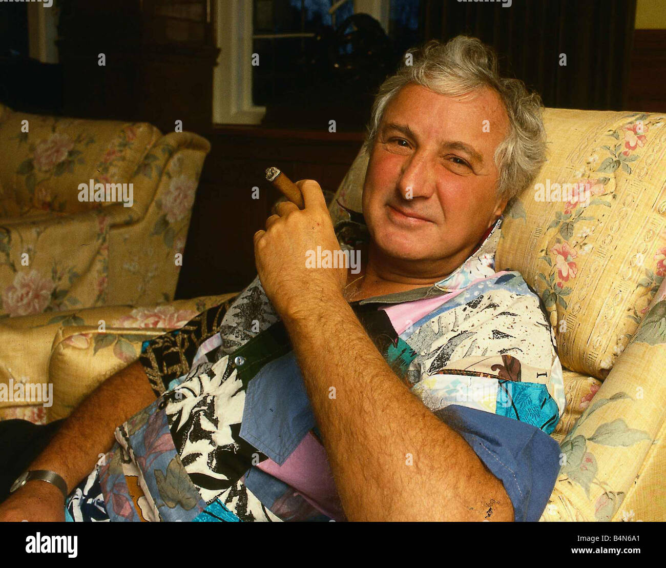 Michael Winner at home smoking cigar February 1988 Stock Photo - Alamy