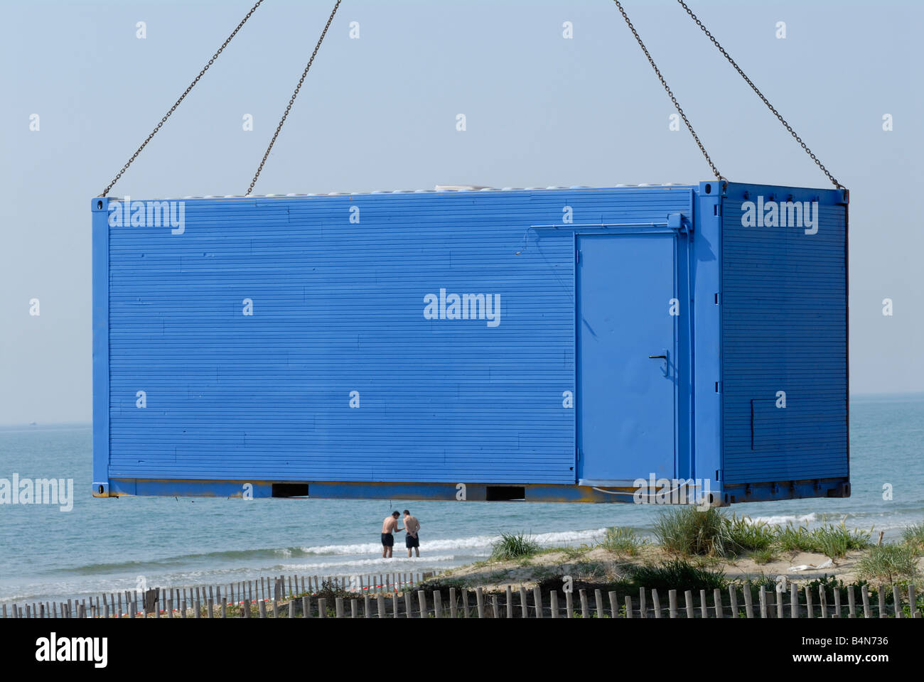two persons under container Stock Photo - Alamy