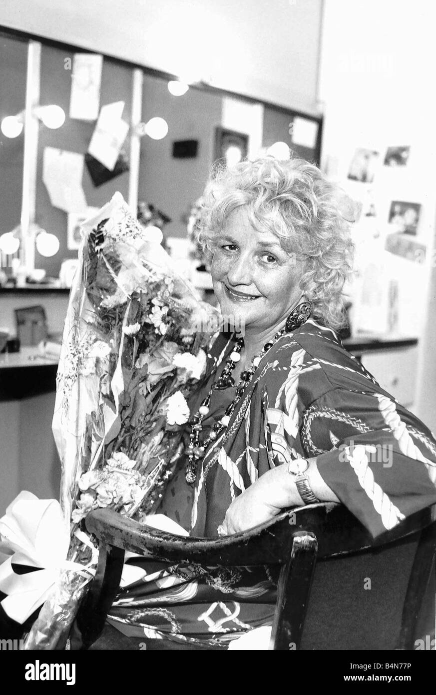 Jean Boht actress sits in dressing room holding bouquet of flowers May ...