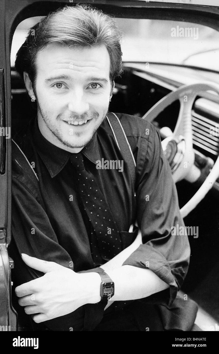 Midge Ure singer pop group Ultravox music sitting in car arms folded ...