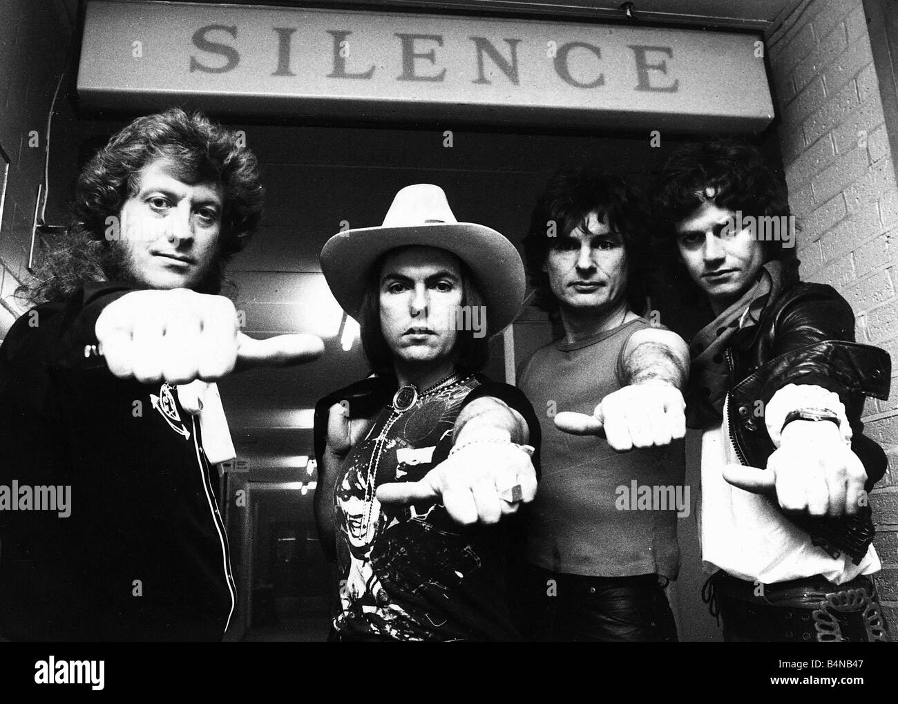 Slade pop group 1981 standing in front of a Silence sign with their ...