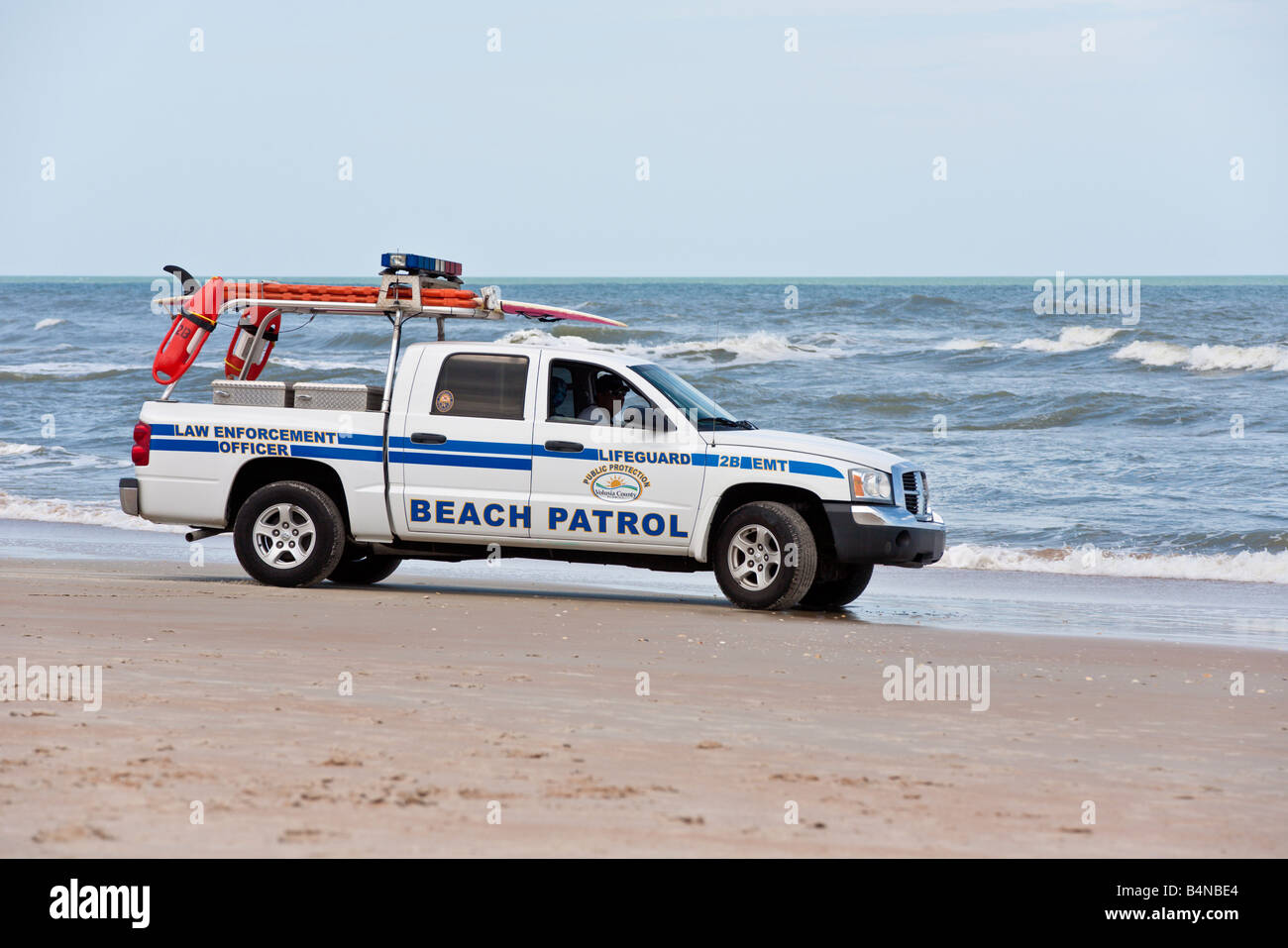 Beach patrol safety officers driving truck on beach in Ormond Beach ...