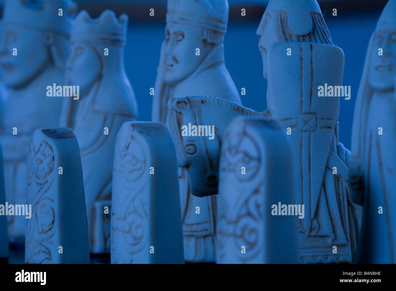 Old fashioned chess Pieces lined up on blue background Stock Photo - Alamy