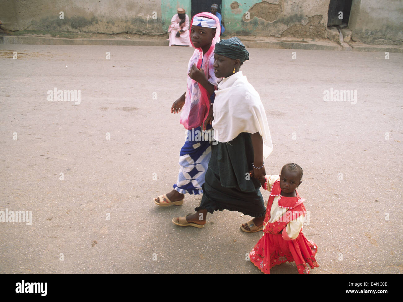 three people walking down a street zaria nigeria Stock Photo - Alamy