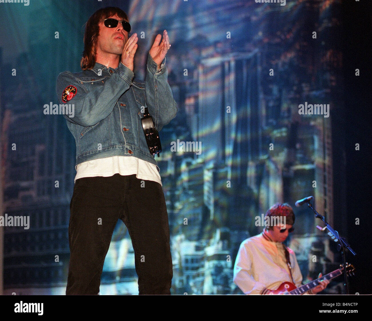 Liam Gallagher and brother Noel Gallagherof Oasis performing on stage ...