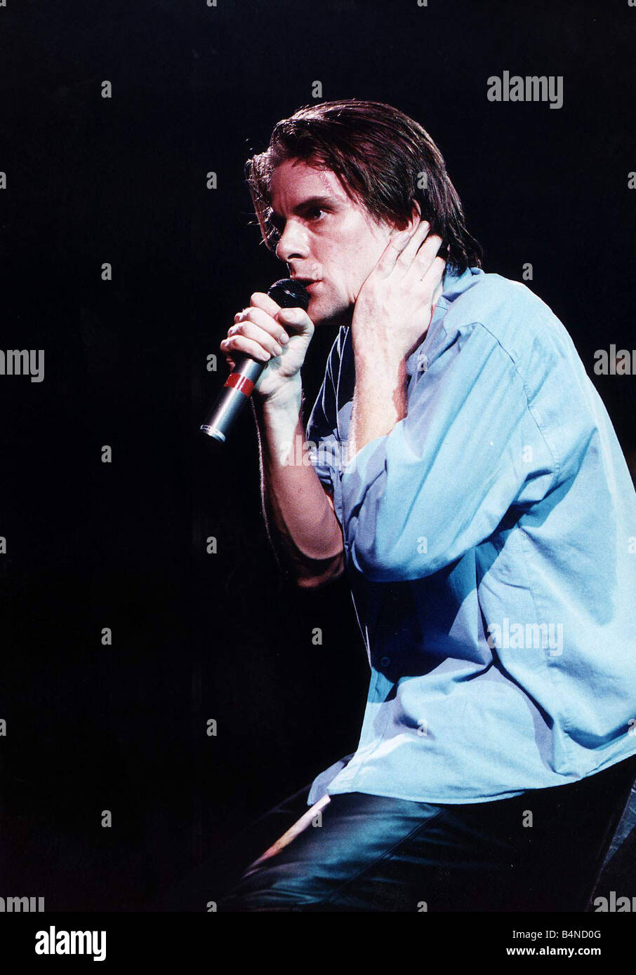 Ricky Ross singer rock band pop group Deacon Blue on stage holding ...