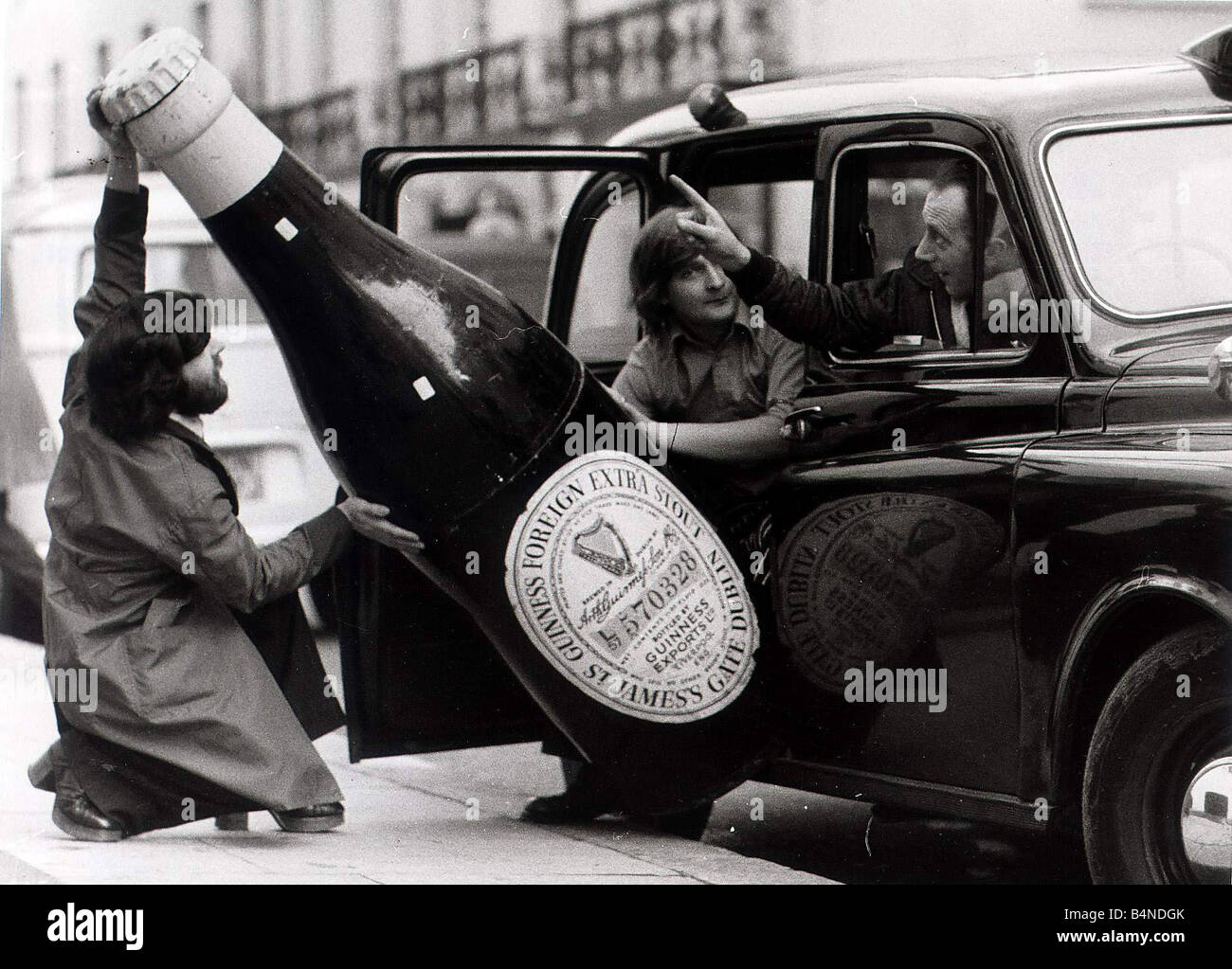 Ron Nicholson left Bill Barnard trying to get a large bottle of ...