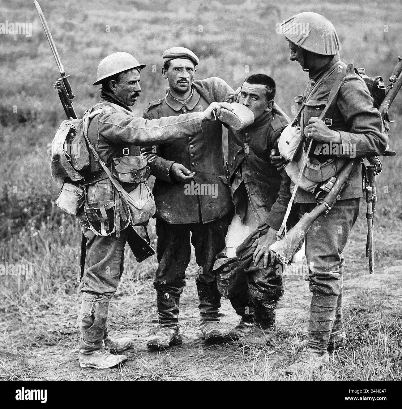 British soldier giving wounded German prisoner a drink 1916 Stock Photo ...
