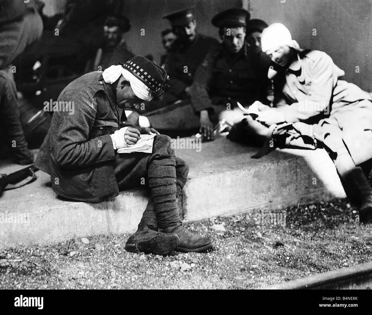 World War One A wounded British soldier sitting on steps with comrades ...