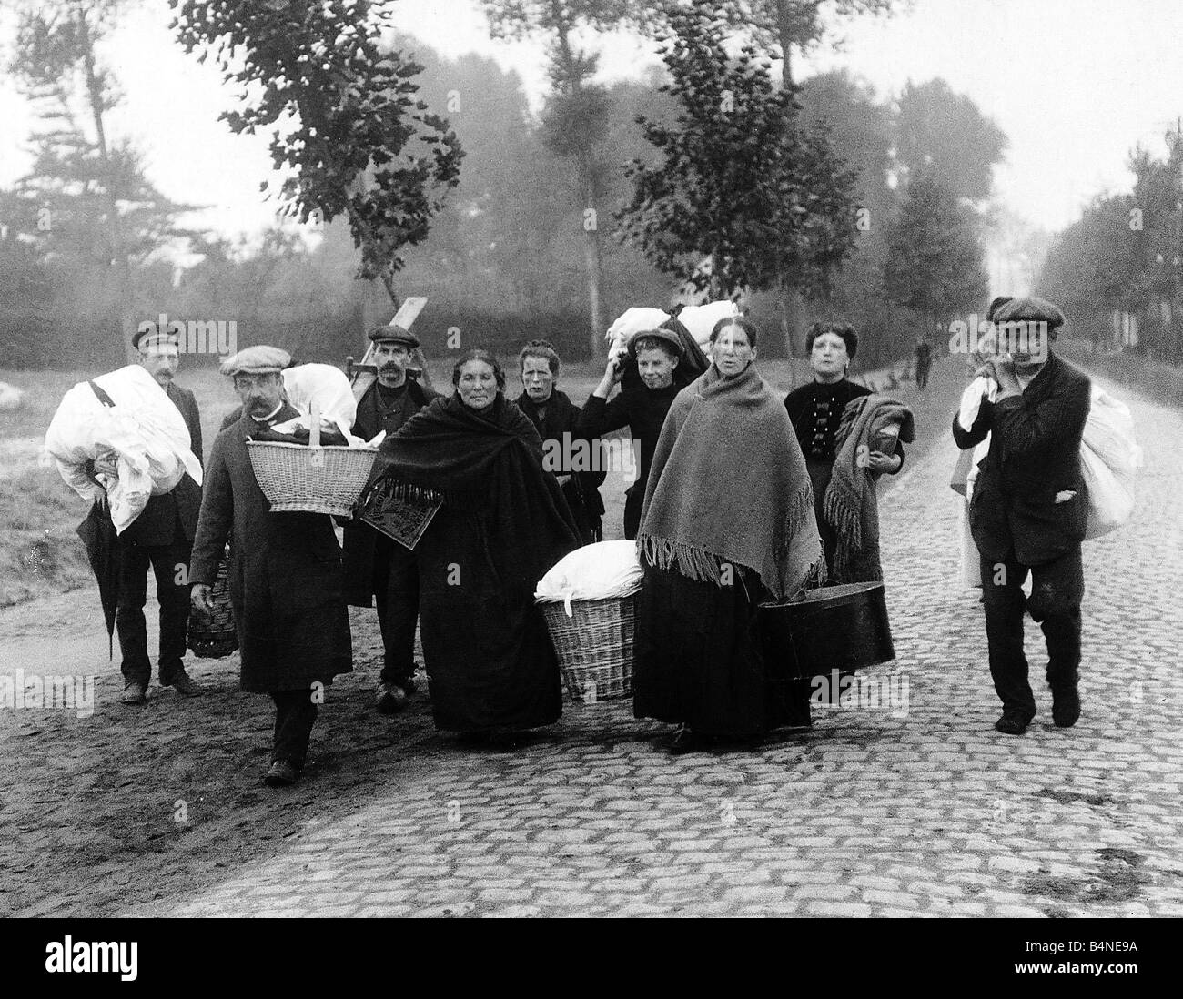 World War One Refugees walk along the road carrying their possessions ...