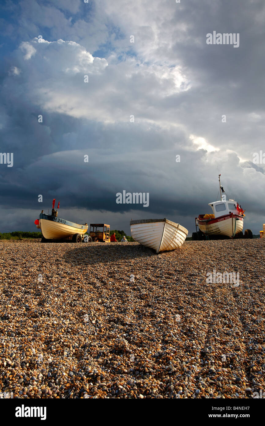 Storm clouds over the shingle beach and fishing boats at Weybourne on ...