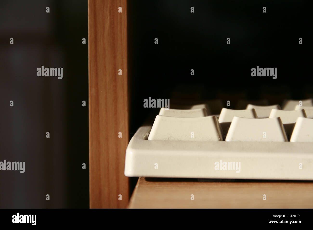 close up detail of pc keyboard on wooden desk Stock Photo - Alamy