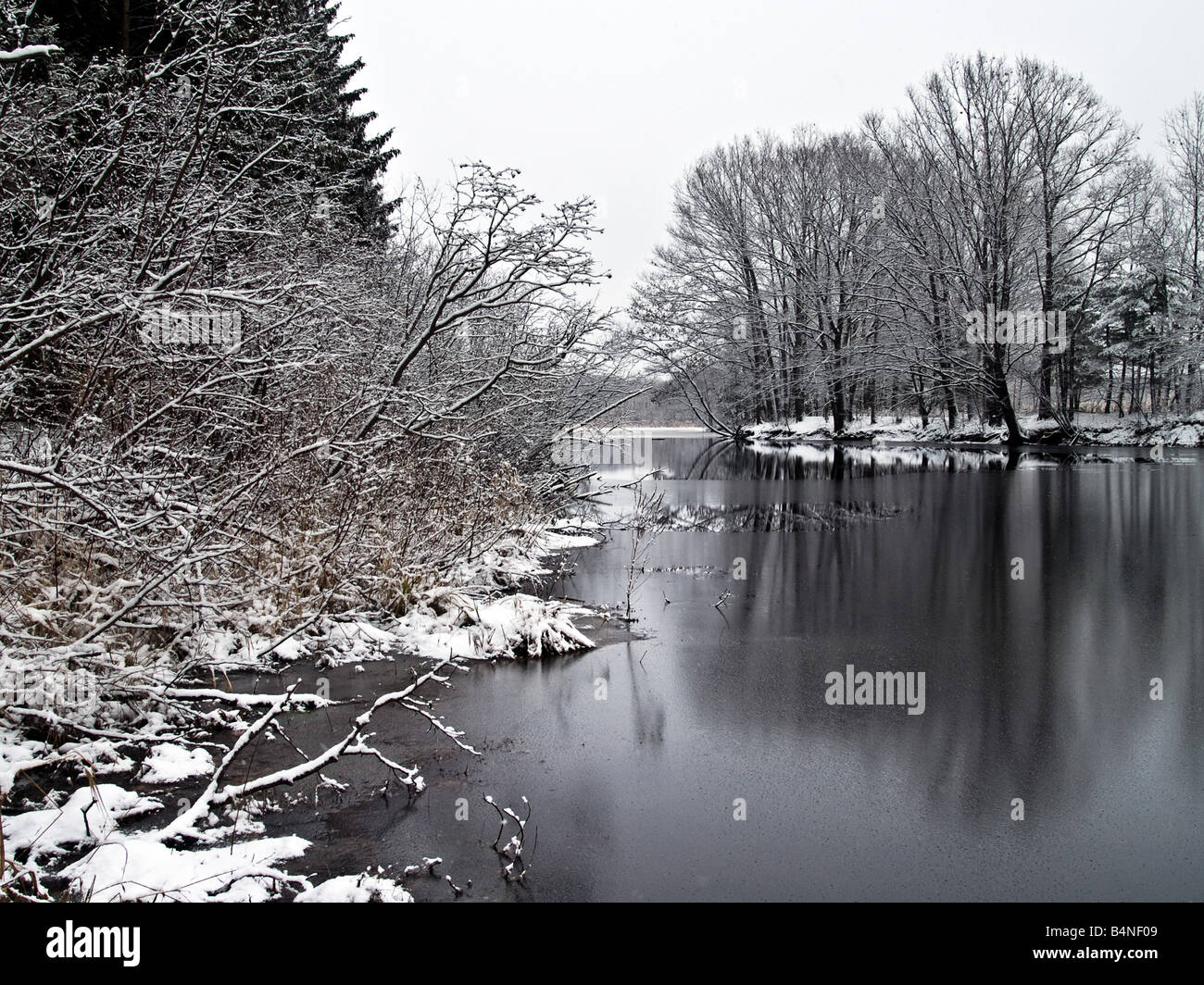 winter wonderland in Pulaski, New York, USA. partially ice covered pond ...