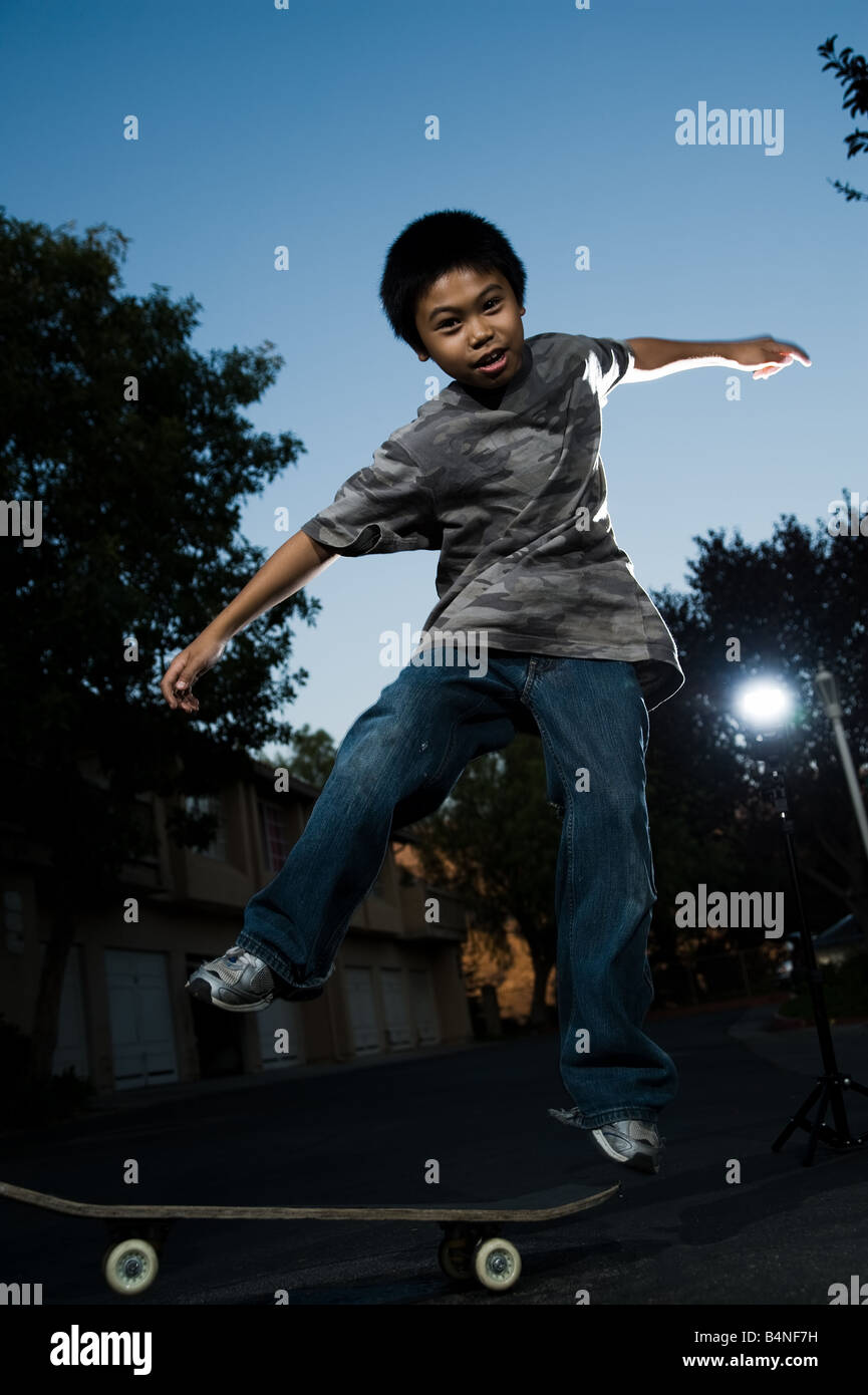 Balancing on a skateboard Stock Photo - Alamy