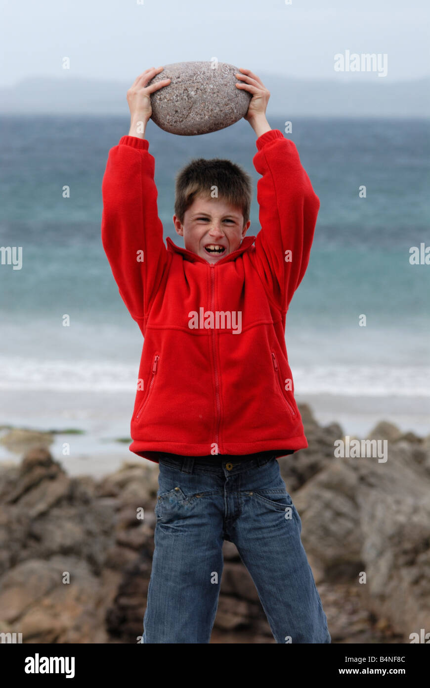 a child holding a stone Stock Photo - Alamy