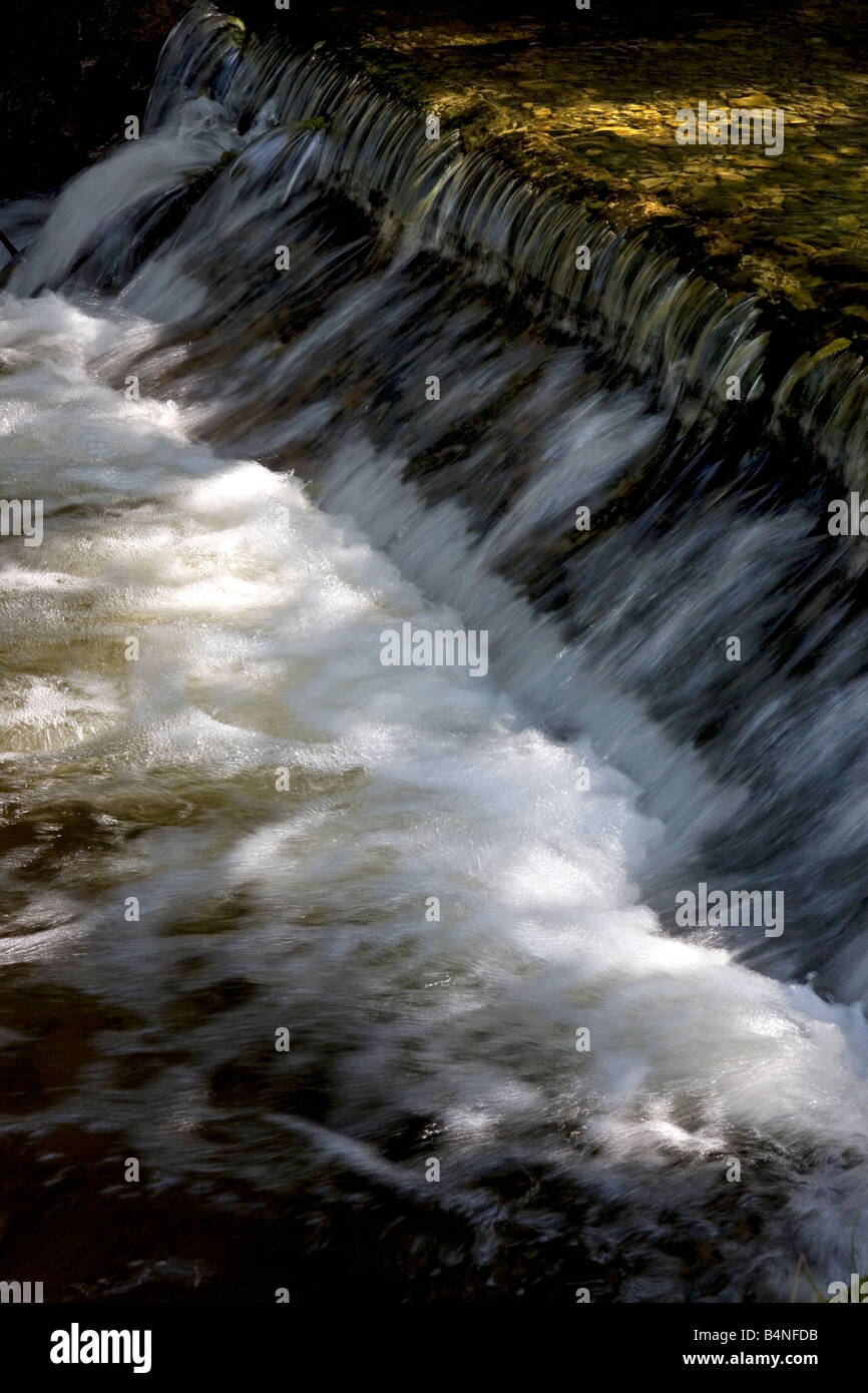 Close up of intake weir on reservoir with water going to small scale ...