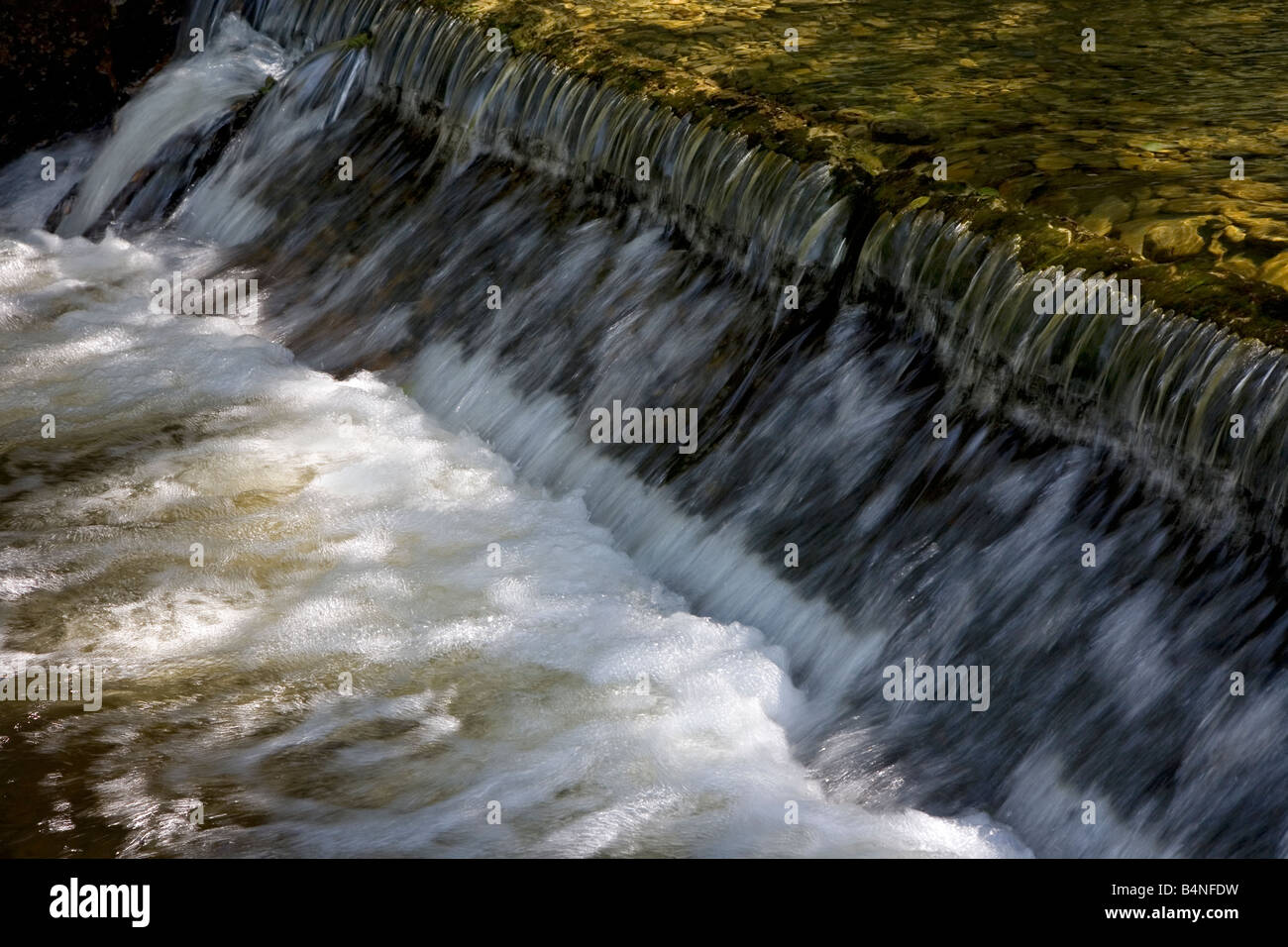 Close up of intake weir on reservoir with water going to small scale ...