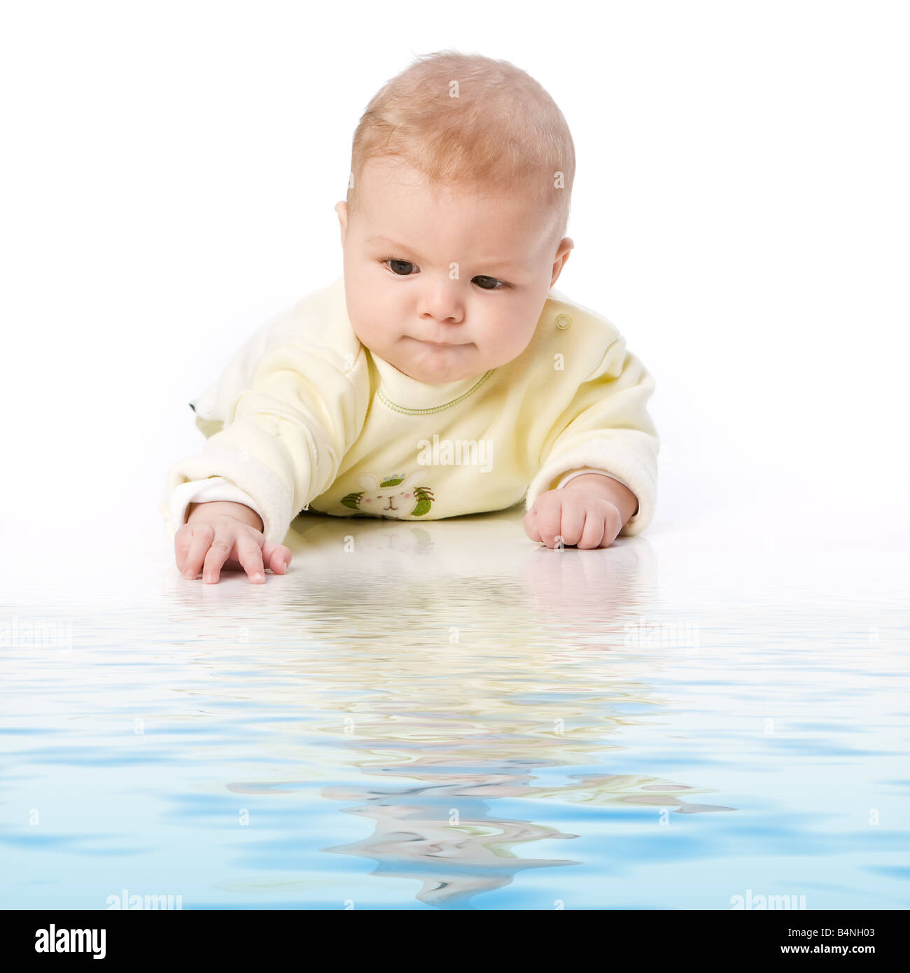 Curious baby boy touching water Stock Photo - Alamy