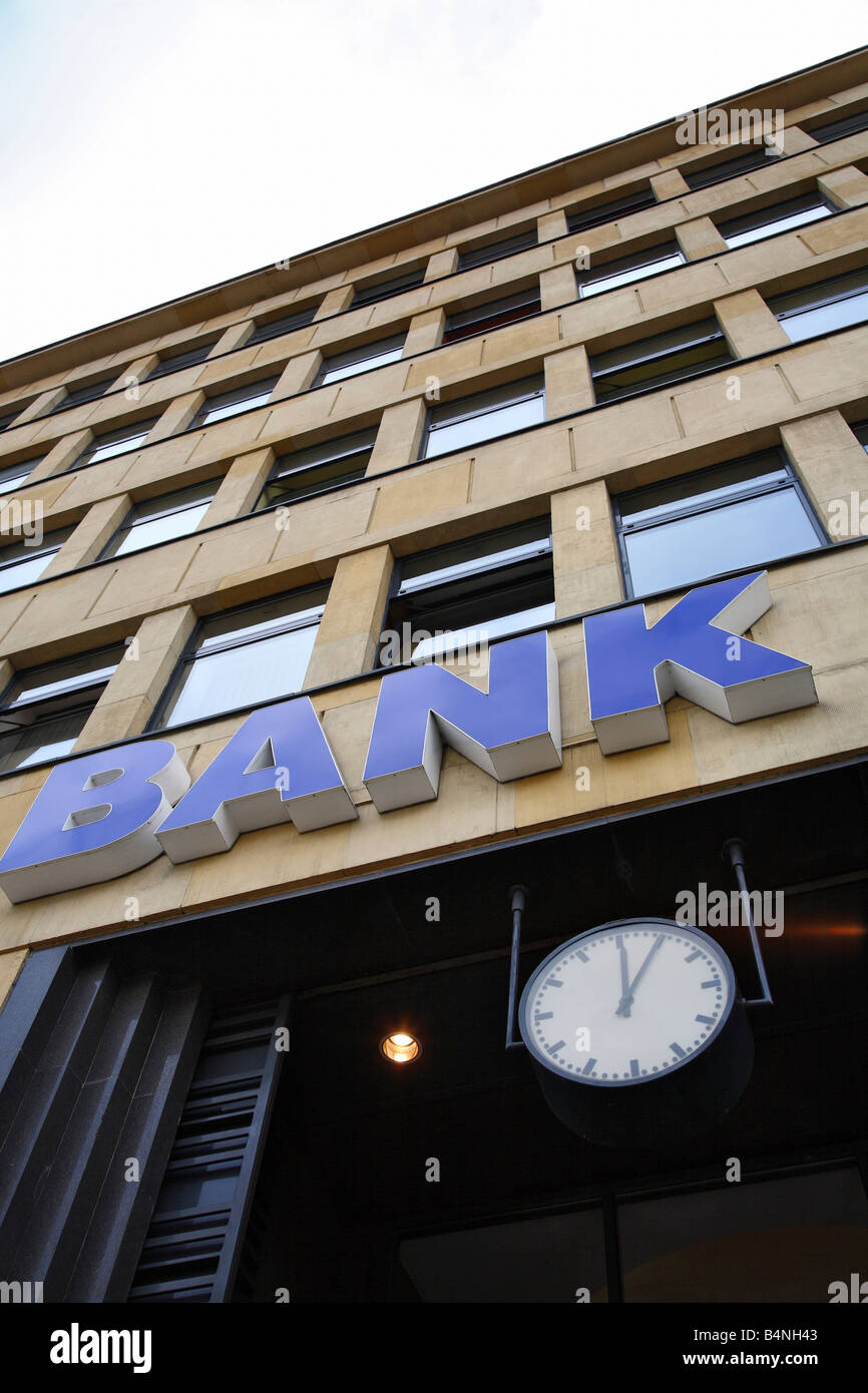 BANK sign on a building and a clock showing five past twelve Stock ...