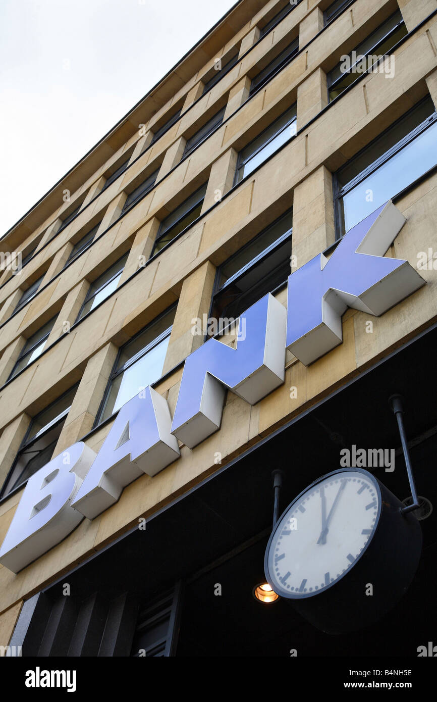 BANK sign on a building and a clock showing five past twelve Stock ...