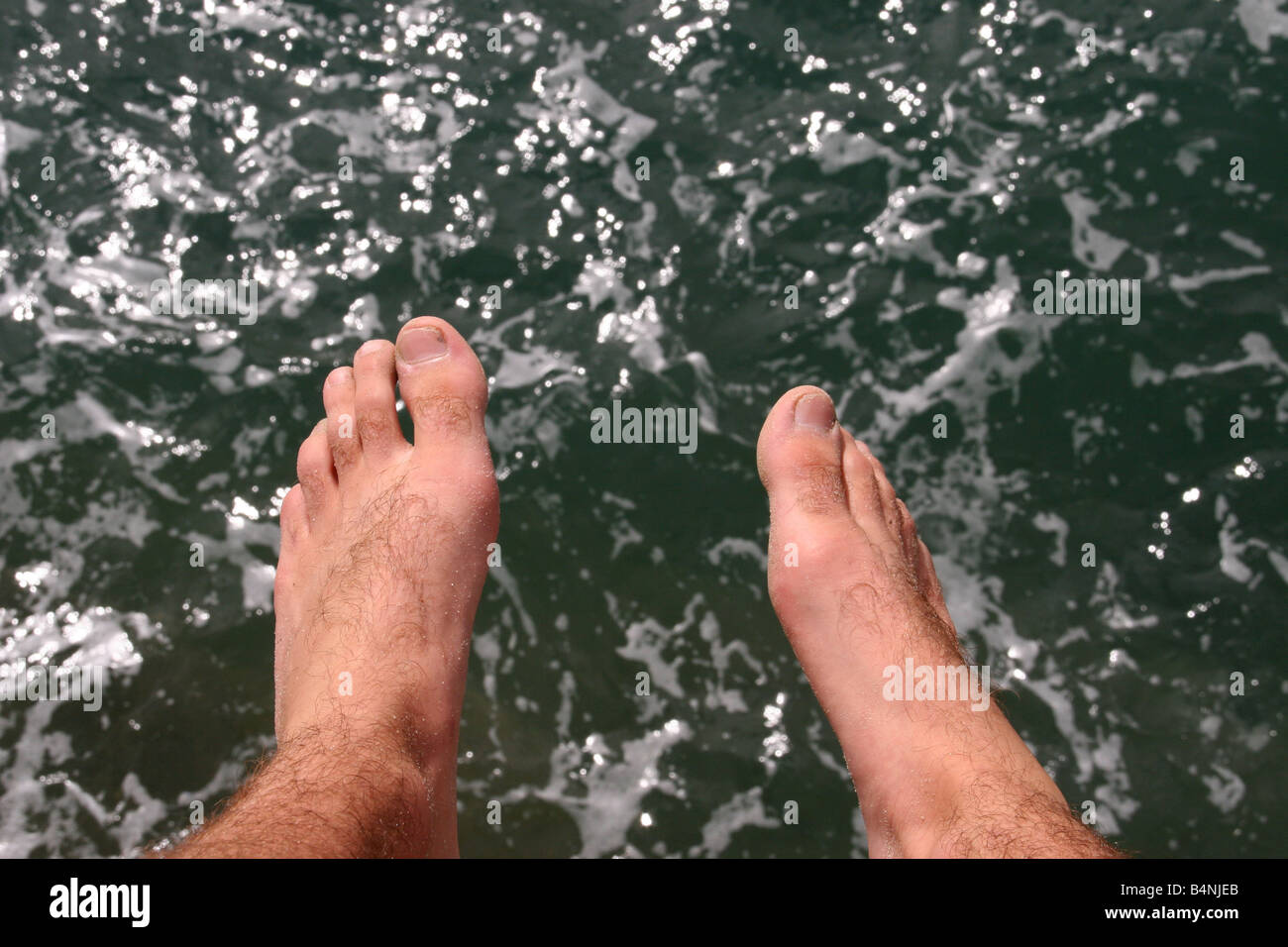 Man dangling legs over water hi-res stock photography and images - Alamy