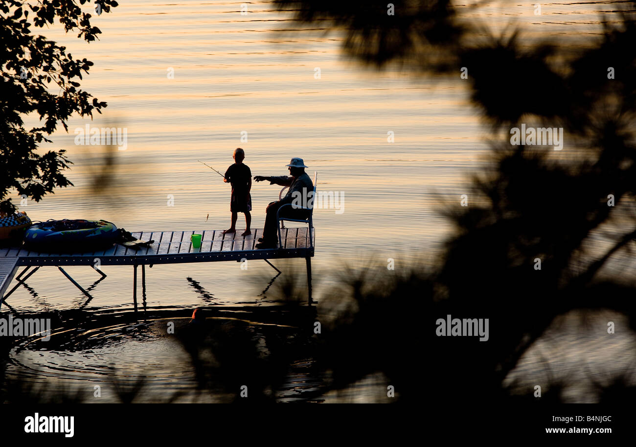 An elderly person helping a young child fish on a northern Wisconsin ...