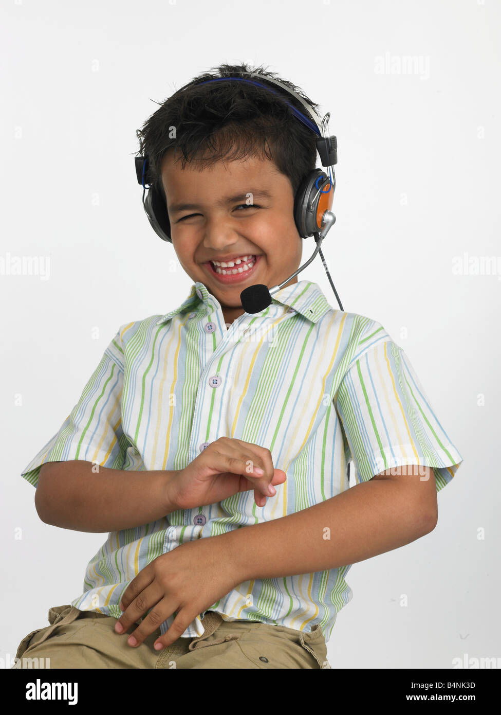 asian boy of indian origin talking to someone on his headphone and ...