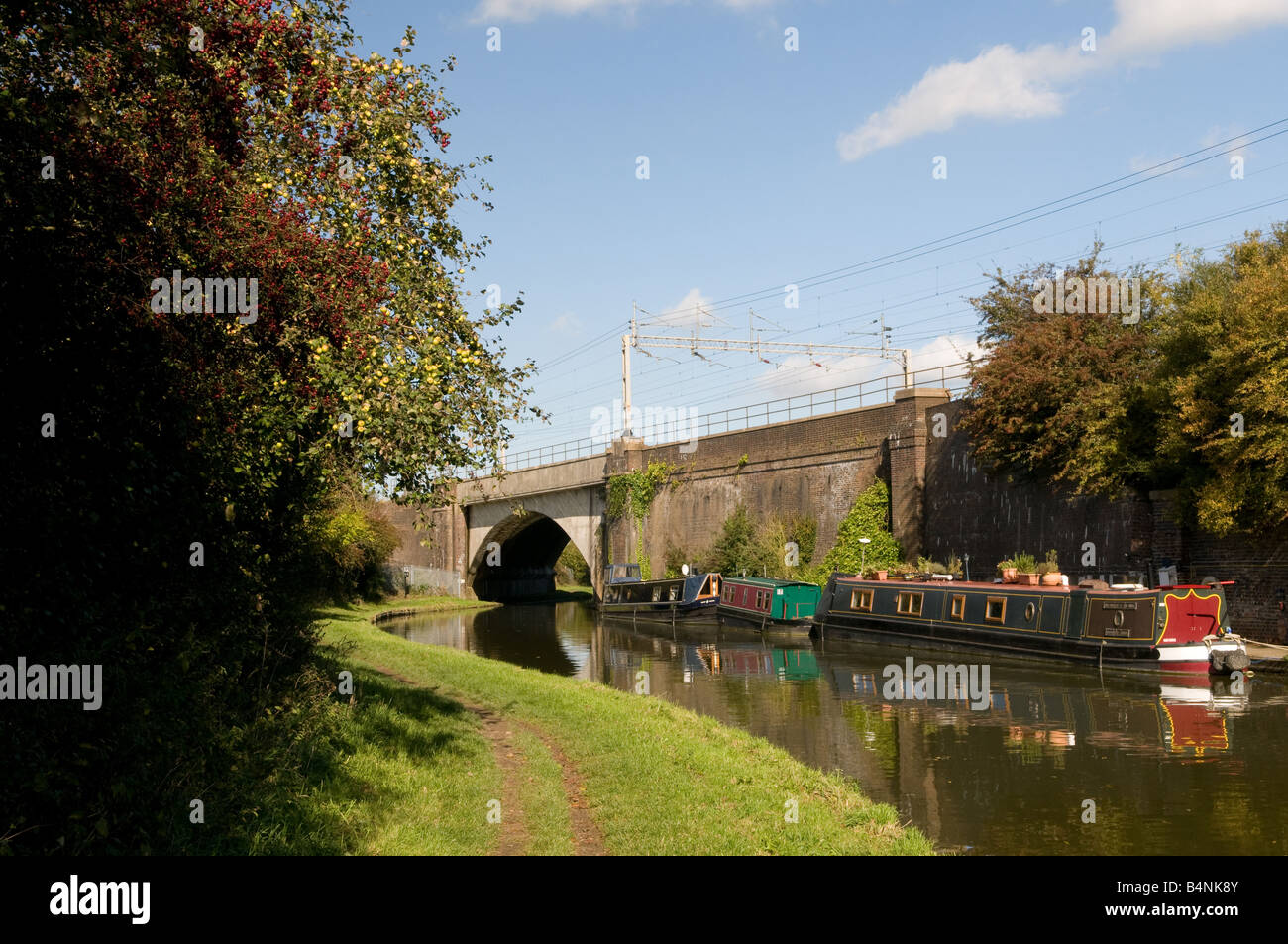 Canal Boat under a railway bridge Stock Photo - Alamy