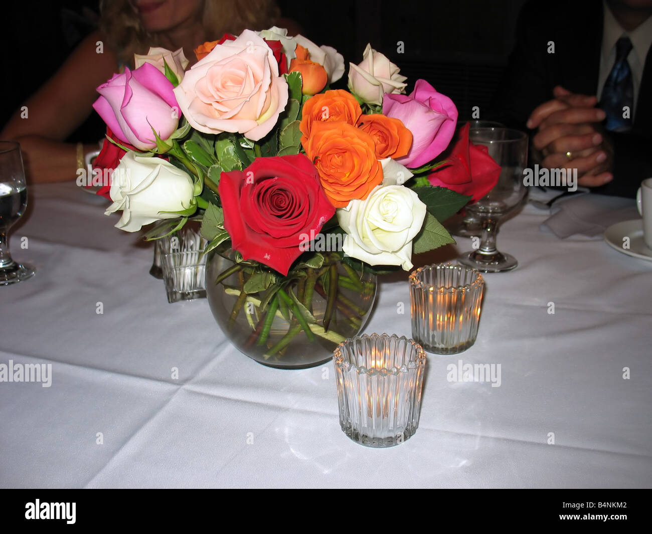 A nice arrangement of colorful roses on a table at an anniversary ...