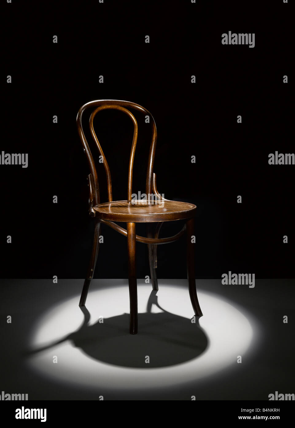 A wooden chair in the spotlight Stock Photo - Alamy