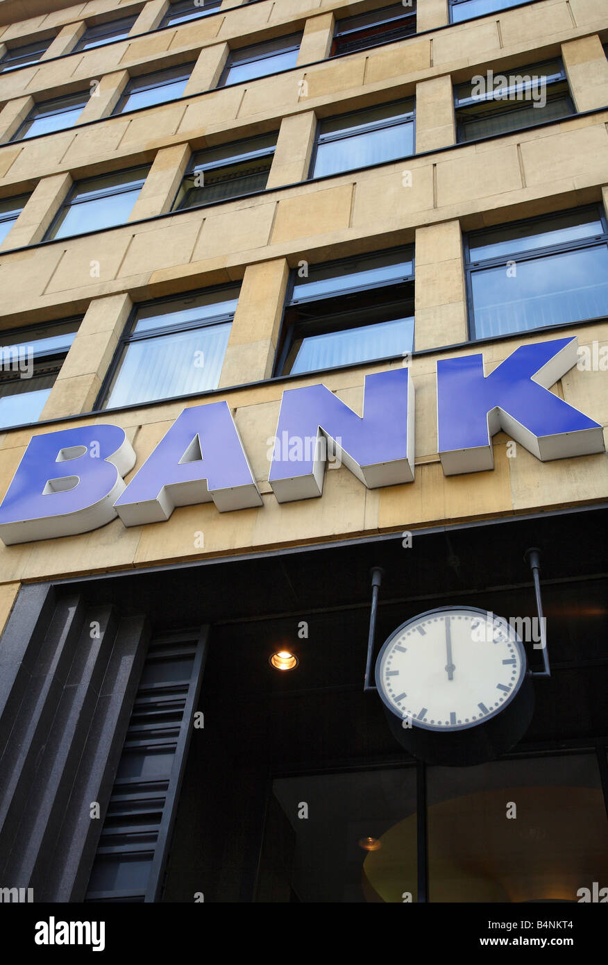 BANK sign on a building and a clock showing twelve o'clock Stock Photo ...
