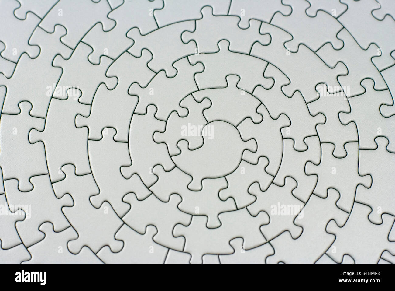 complete grey jigsaw pieces fitting together in form of a spiral adobe ...