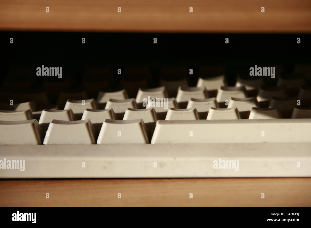 close up detail of pc keyboard on wooden desk Stock Photo - Alamy