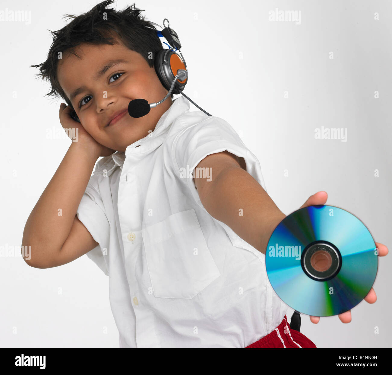 asian boy of indian origin showing off his compact disc Stock Photo - Alamy