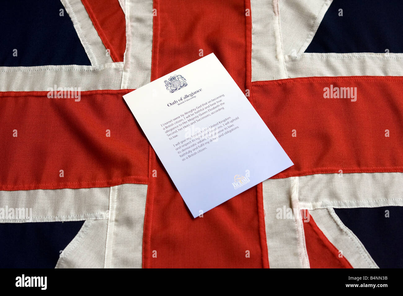 British Citizenship Certificate Displayed On A Union Jack Stock Photo british-citizenship-certificate-displayed-on-a-union-jack-stock-photo