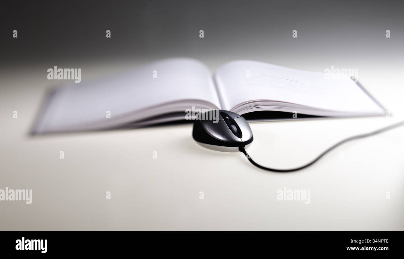 Open book with computer mouse on white background Stock Photo - Alamy