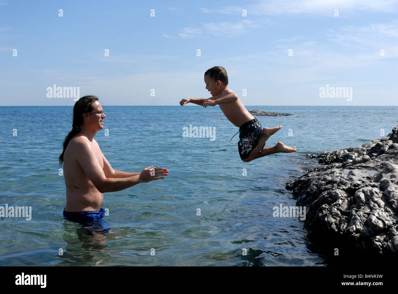 Children jumping off a rock hi-res stock photography and images - Alamy