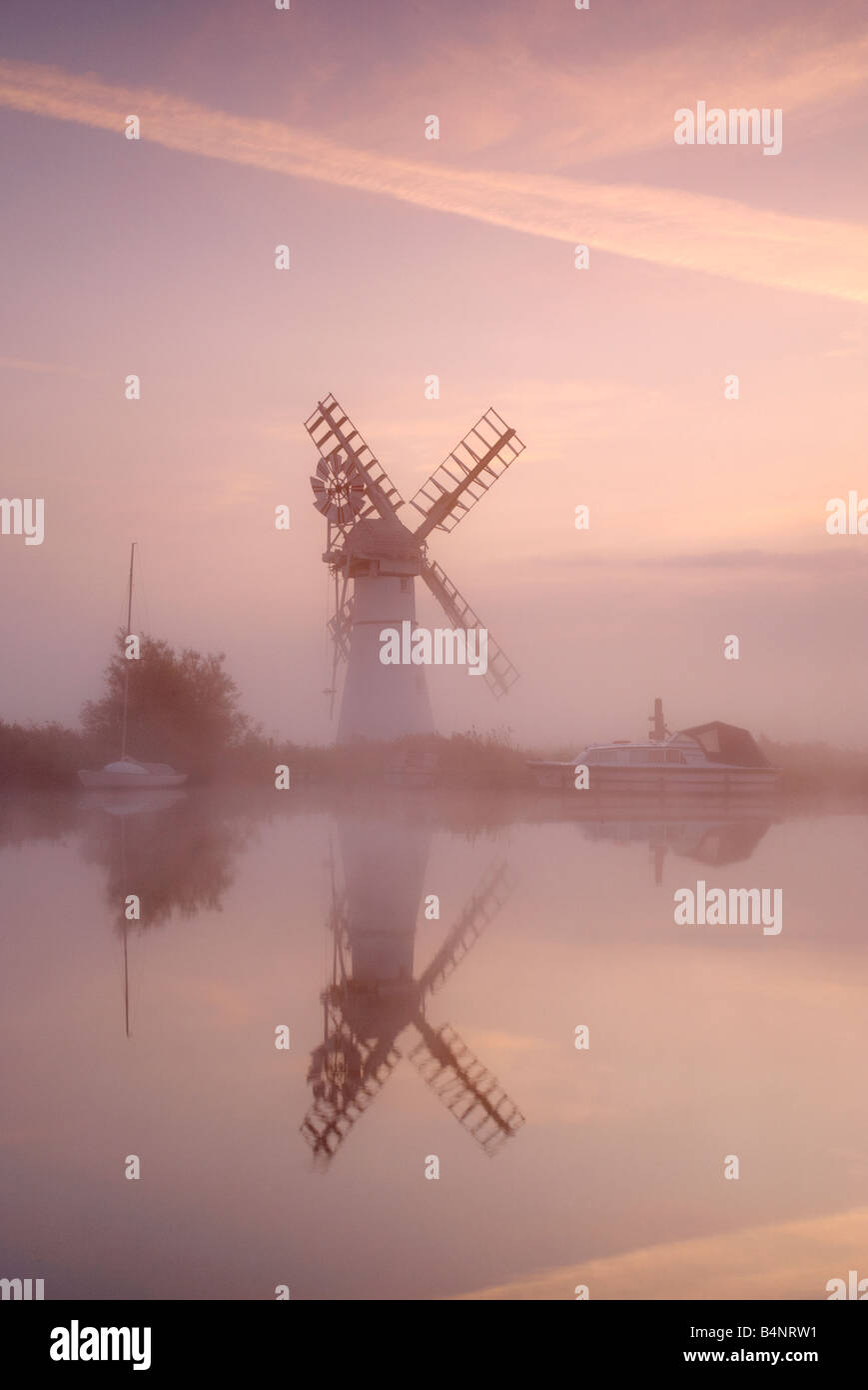 Thurne windmill and a misty River Thurne at dawn on the Norfolk Broads ...