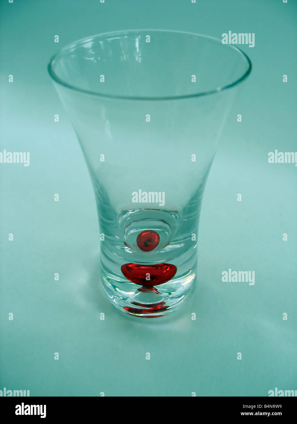 a unique isolated shot glass red glass bubble in the base Stock Photo ...