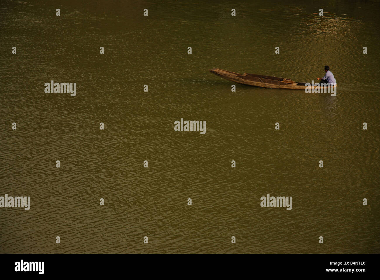 A man paddles a canoe into the village of Changan in rural Guizhou ...