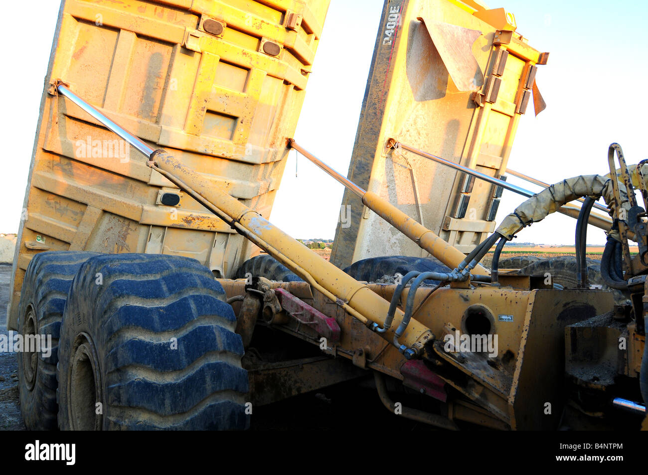 Off road dump trucks at a construction site made by Cat or Caterpillar ...