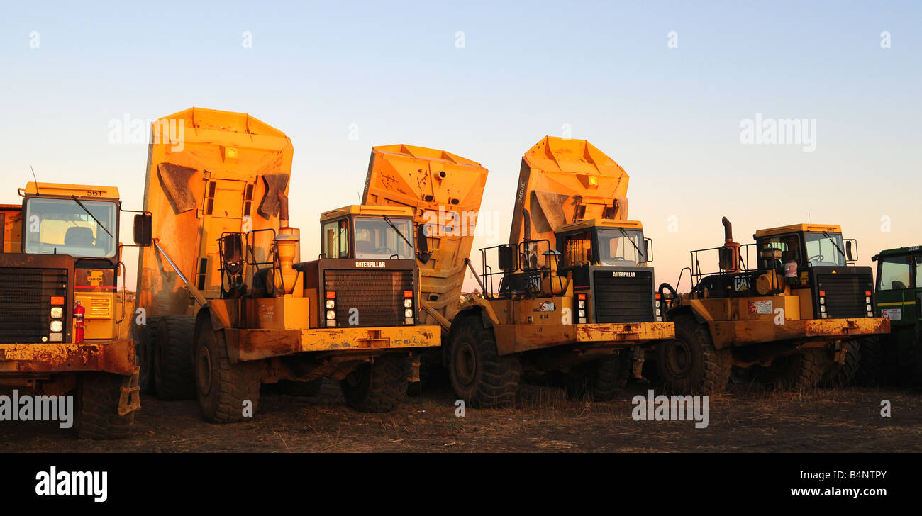 Off road dump trucks at a construction site made by Cat or Caterpillar ...