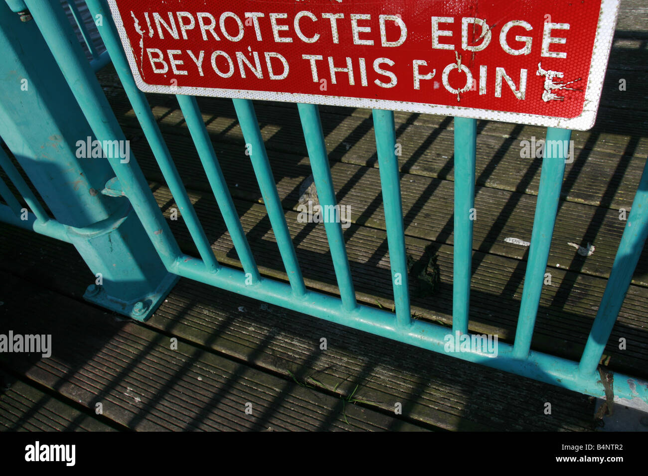 unprotected edge beyond this point sign by sea in wales, uk Stock Photo ...